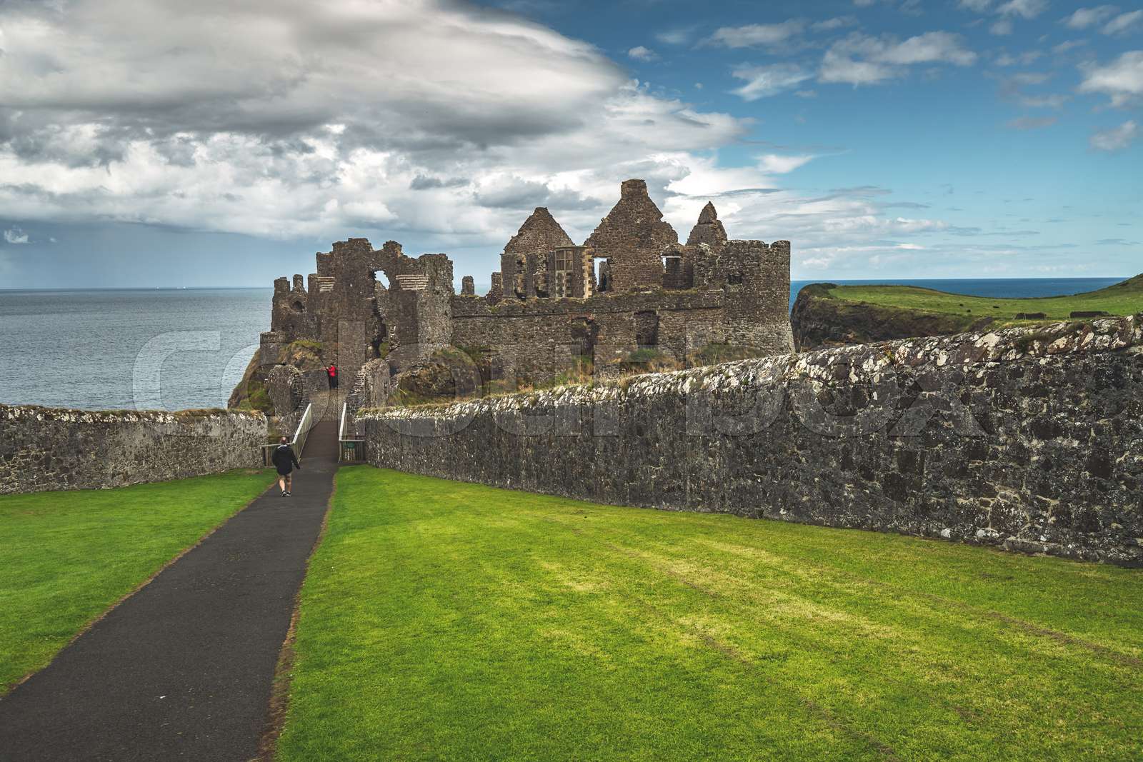 Tourist walking to main entrance of Dunluce castle | Stock image ...