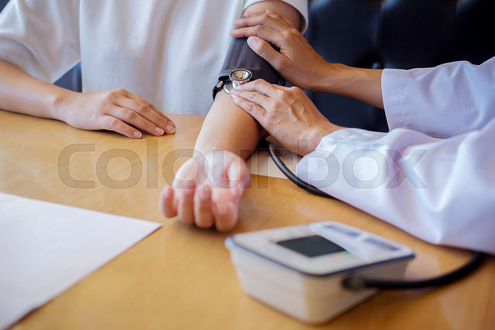 Patient listening intently to a male doctor explaining patient symptoms ...