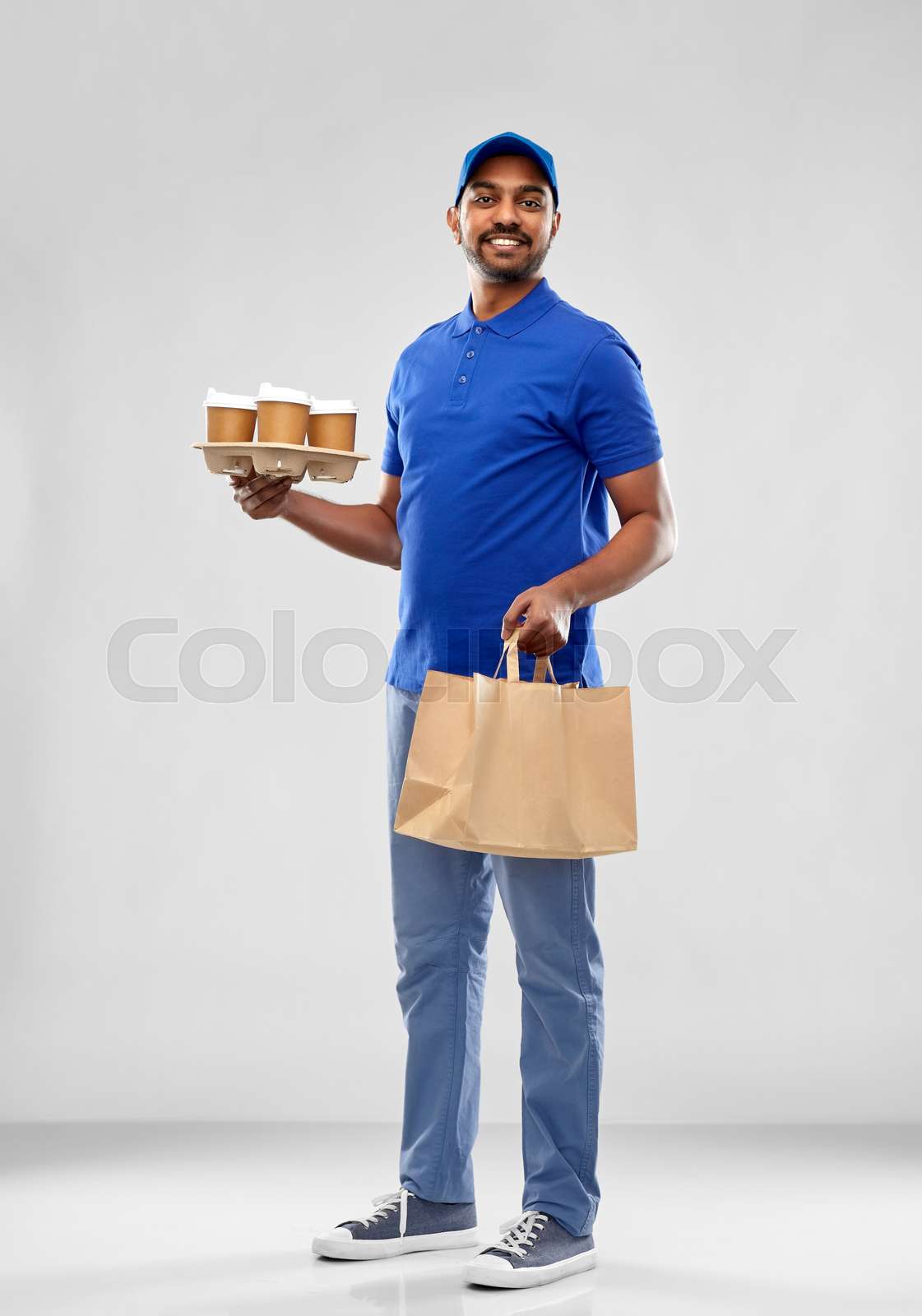 happy indian delivery man with food and drinks | Stock image | Colourbox