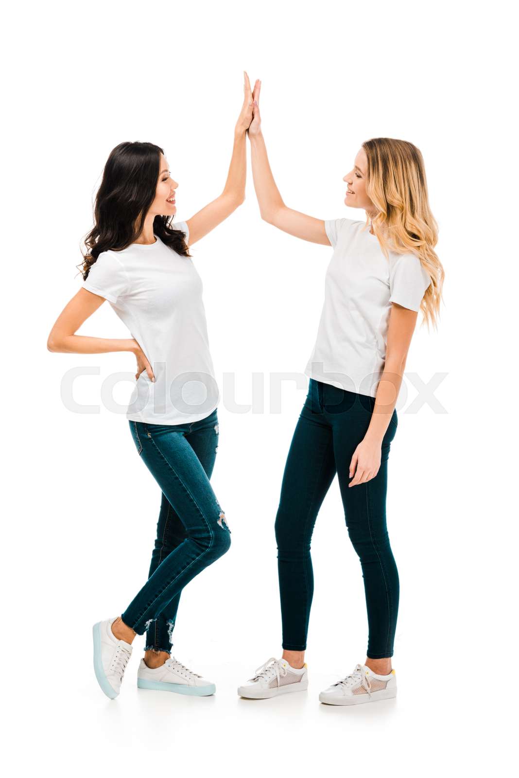 happy young women giving high five and smiling each other isolated on ...