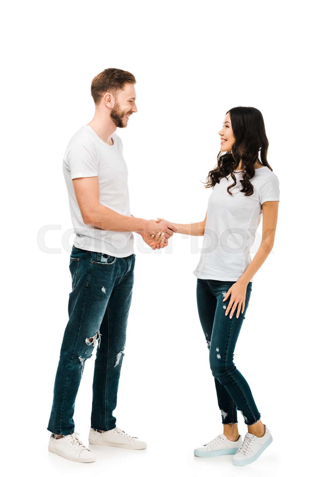happy young couple shaking hands and smiling each other isolated on ...