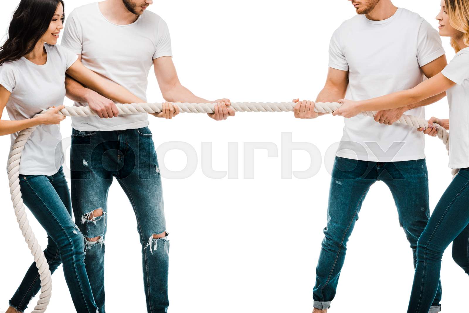 cropped shot of young couples pulling rope and playing tug of war ...