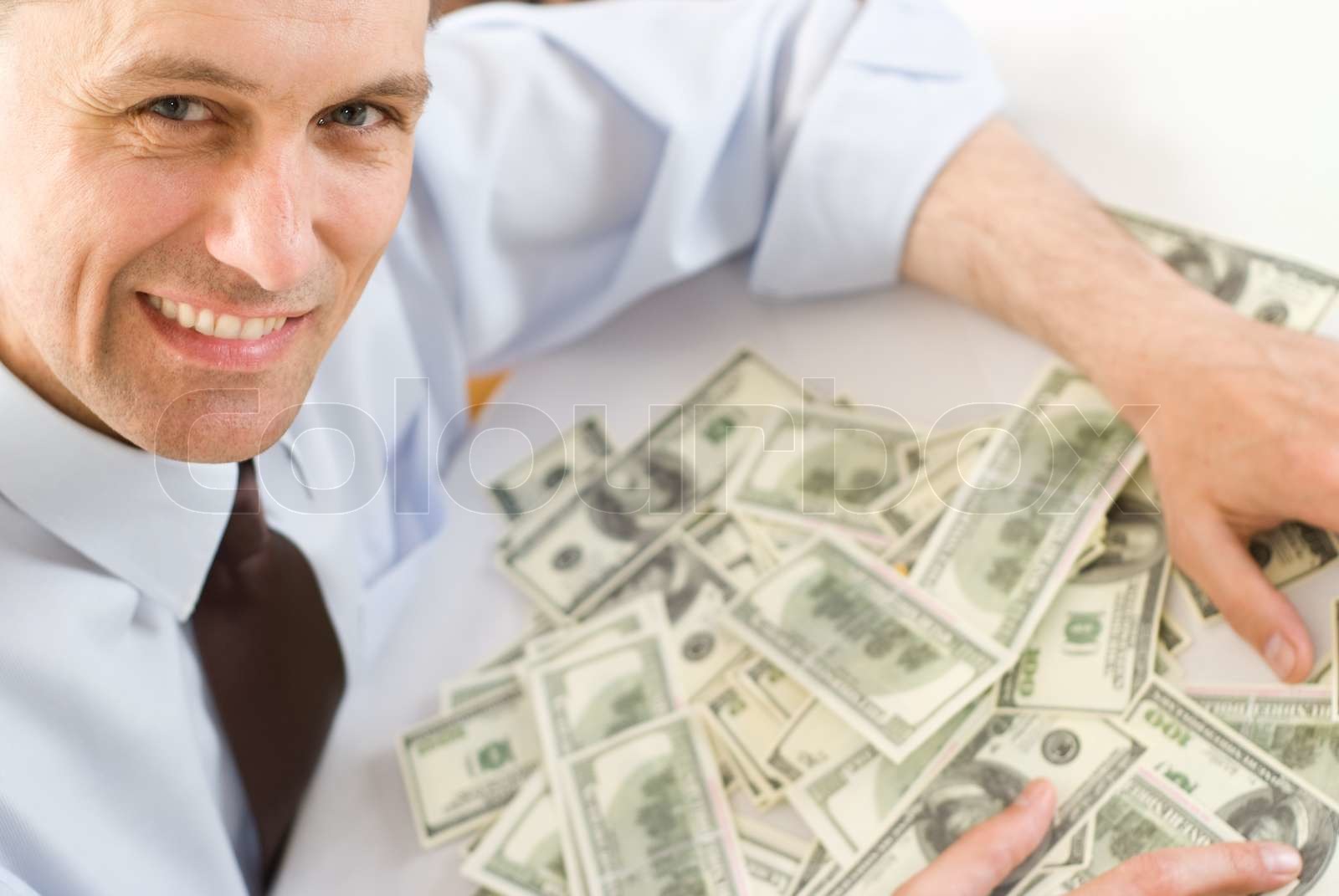 young man holding money | Stock image | Colourbox