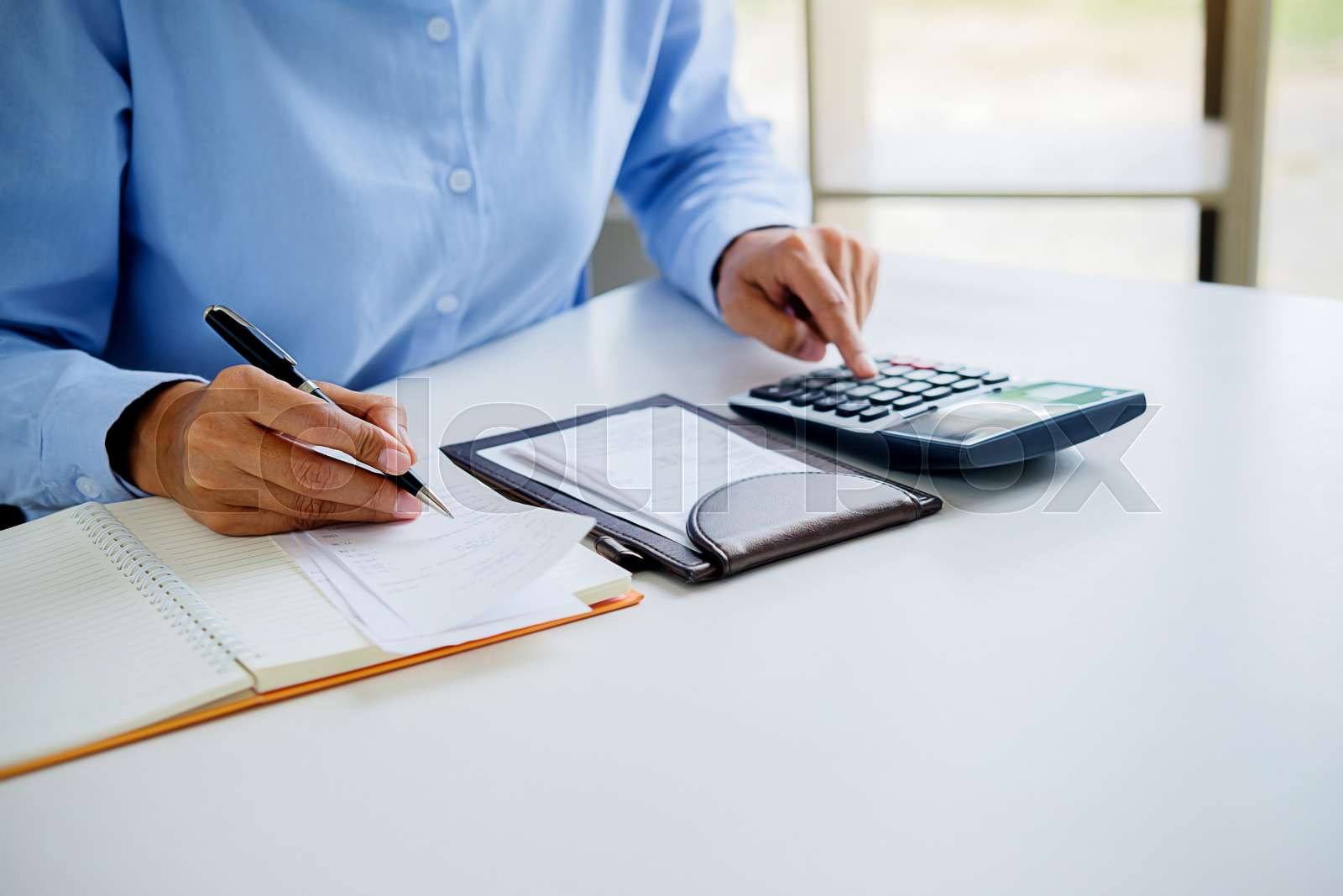 Woman with bills and calculator. Woman using calculator to calculate ...