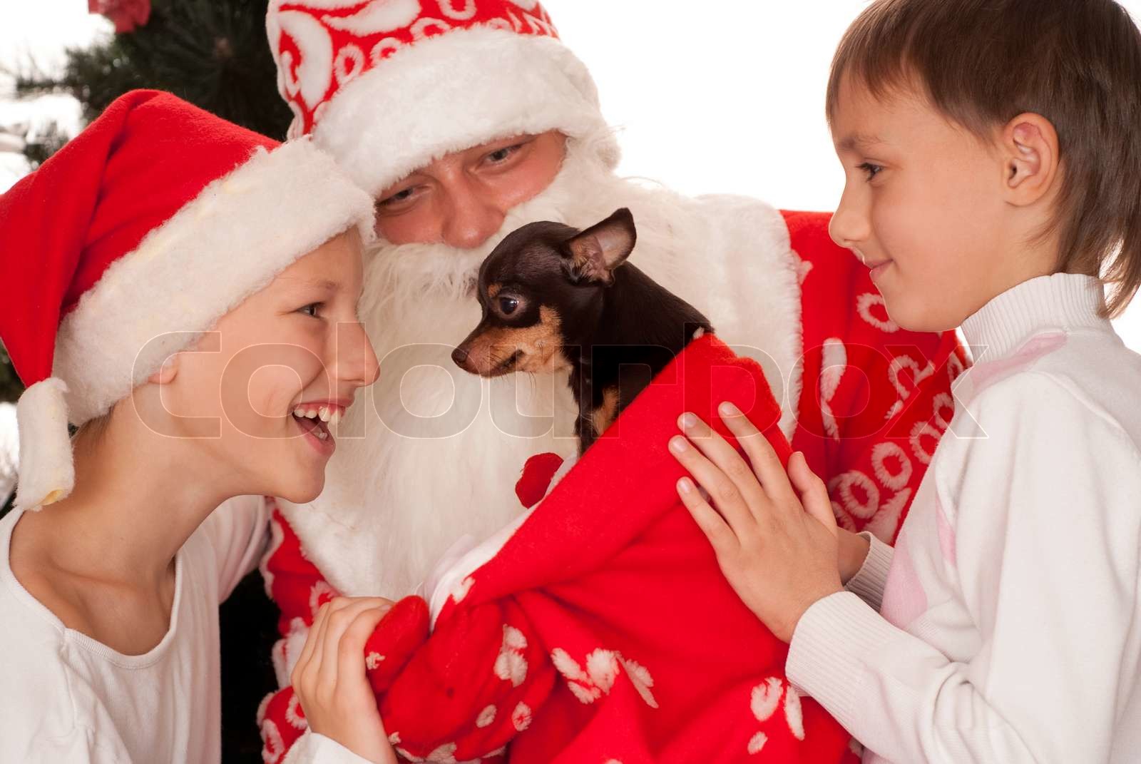 Santa gives presents to children | Stock image | Colourbox
