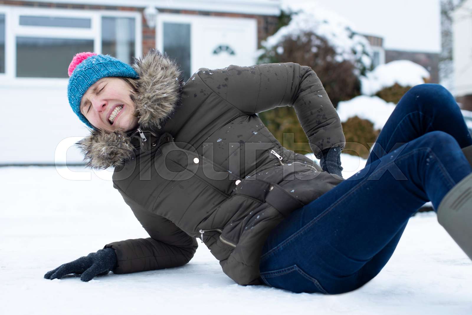 Woman In Pain Falling Over In Snowy On Slippery Street And Injuring ...
