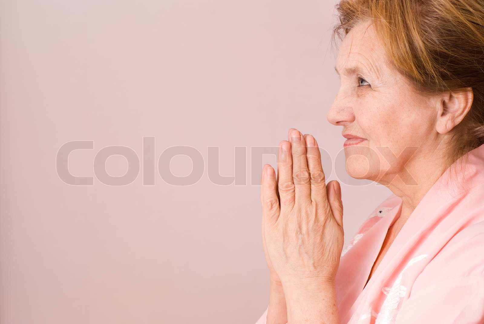 elderly woman praying | Stock image | Colourbox