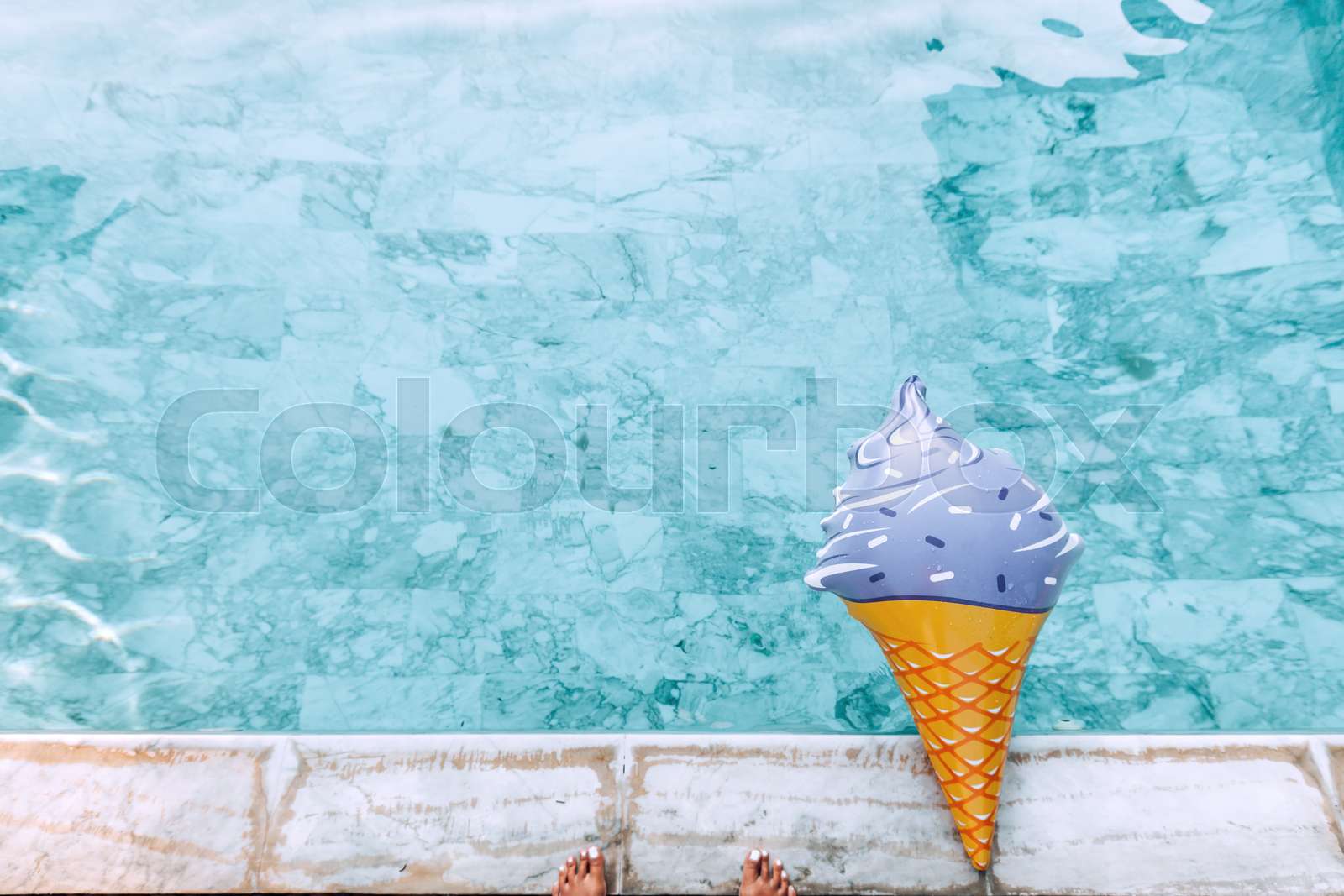 Ice cream pool float in blue water | Stock image | Colourbox