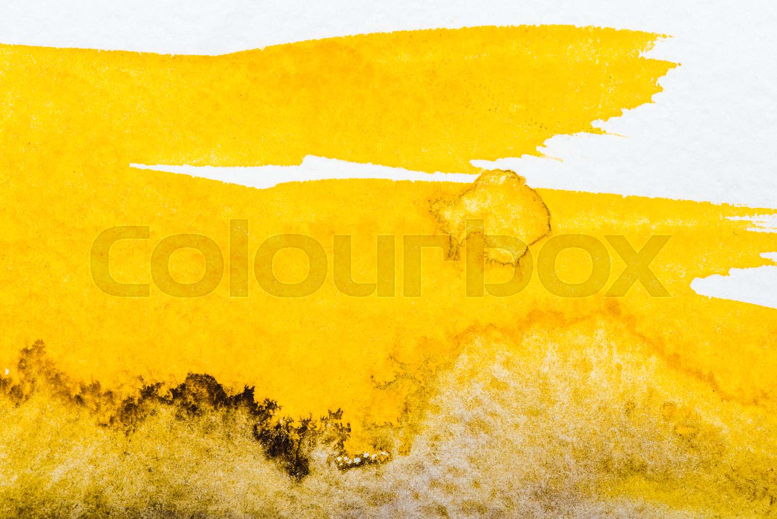top view of yellow watercolor spill on white paper | Stock image ...
