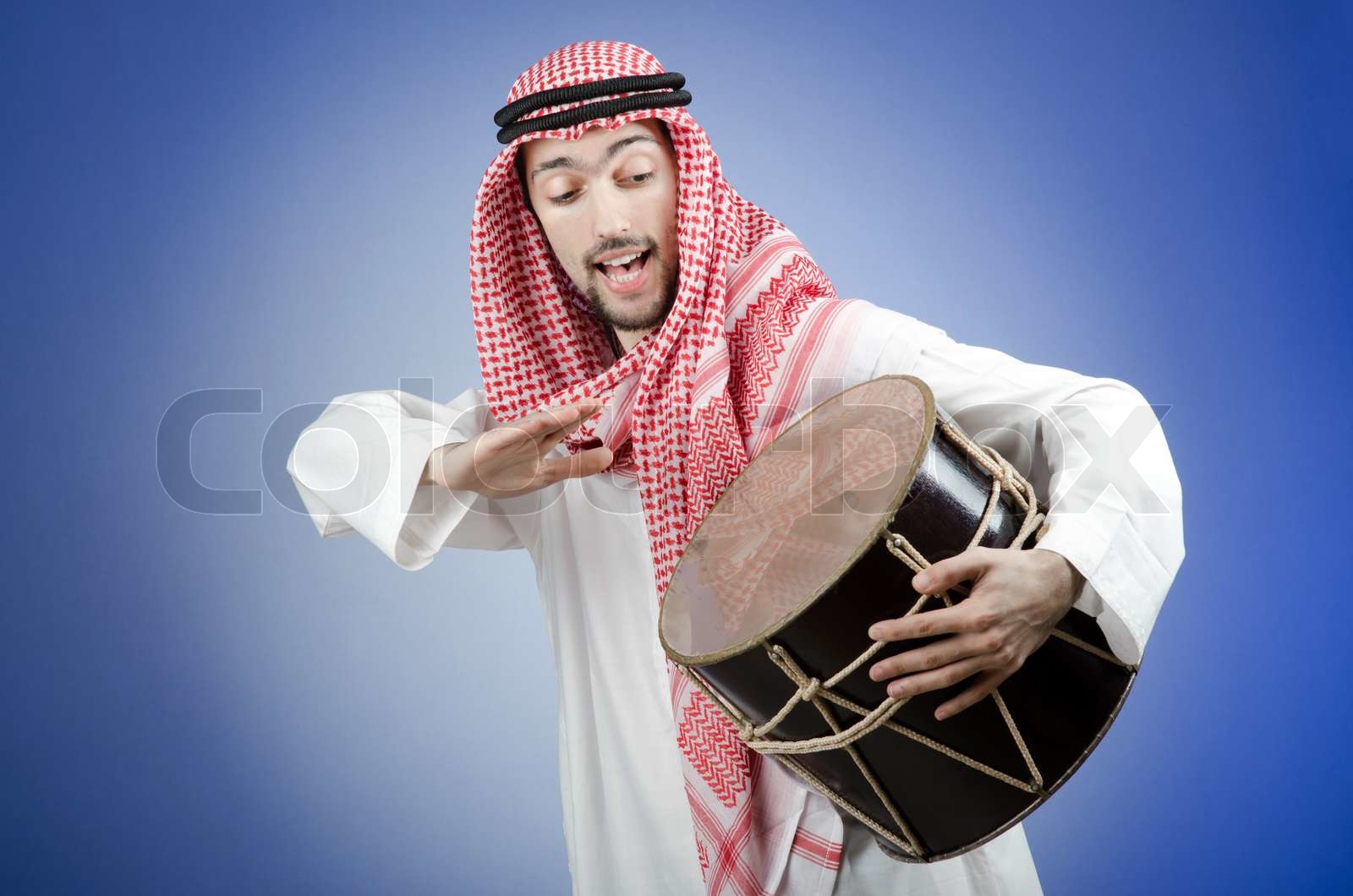 Arab playing drum in studio shooting | Stock image | Colourbox