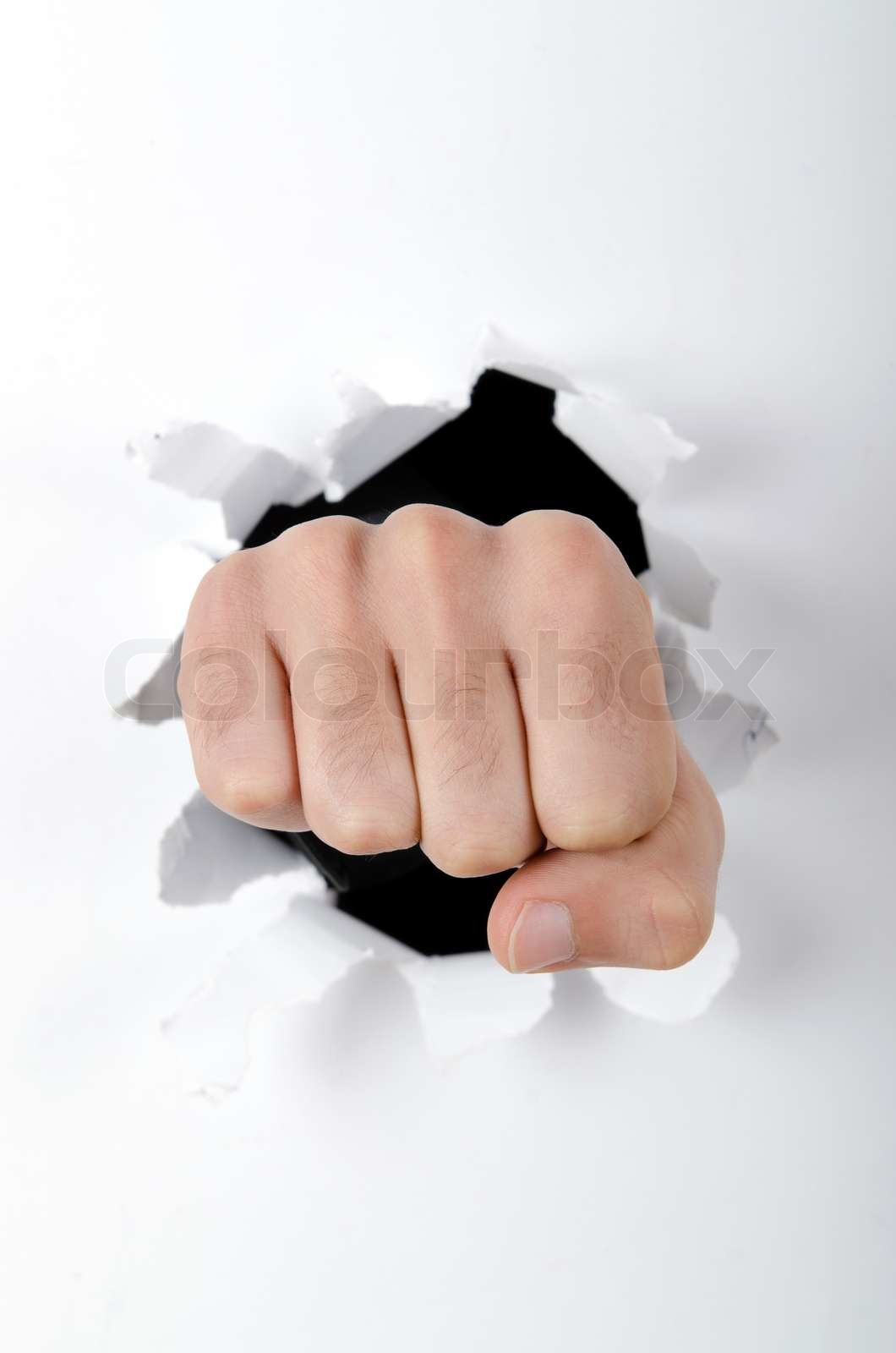 Hand through the hole in paper | Stock image | Colourbox