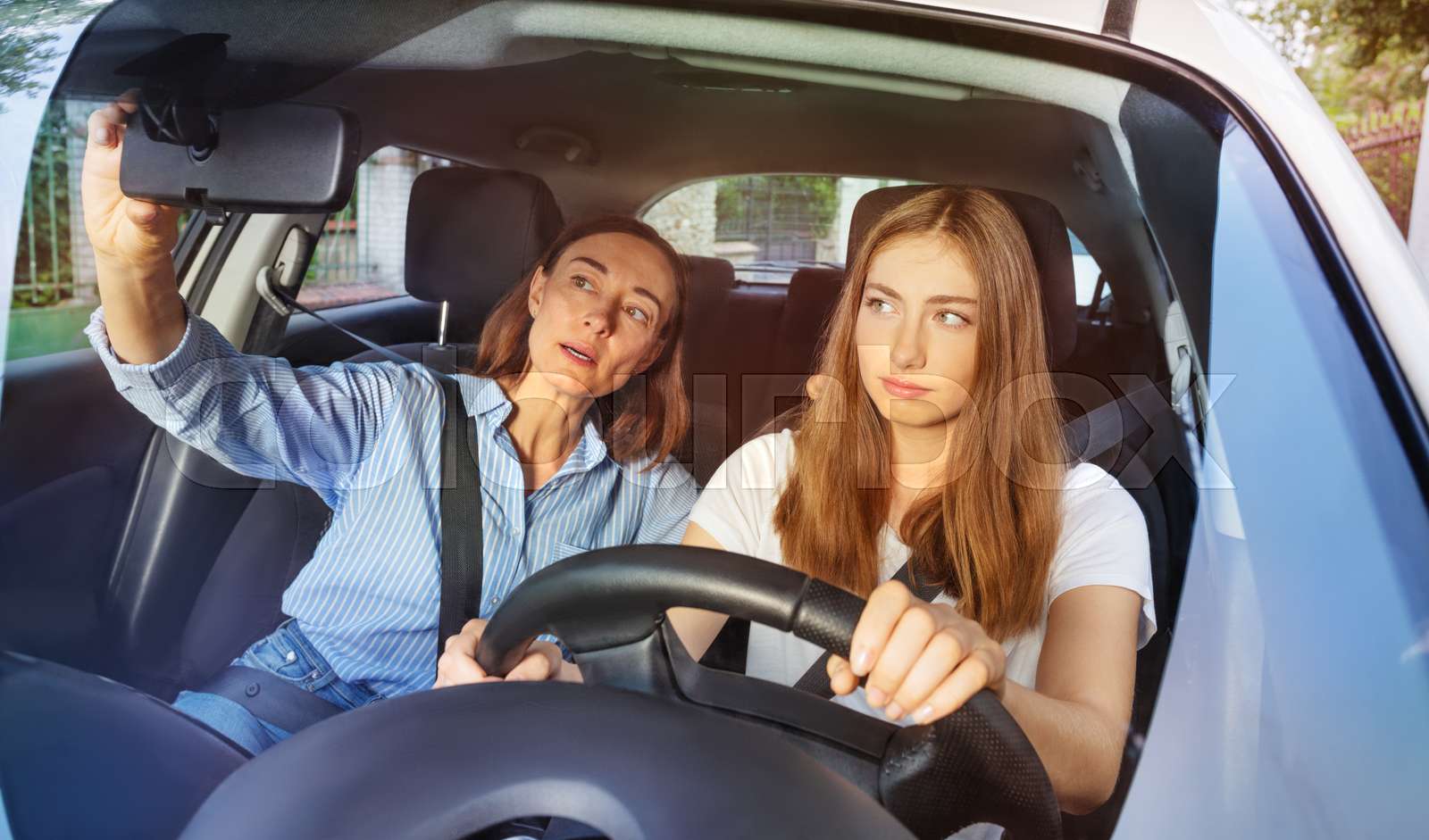 Girl and her mother during driving lesson in a car | Stock image ...