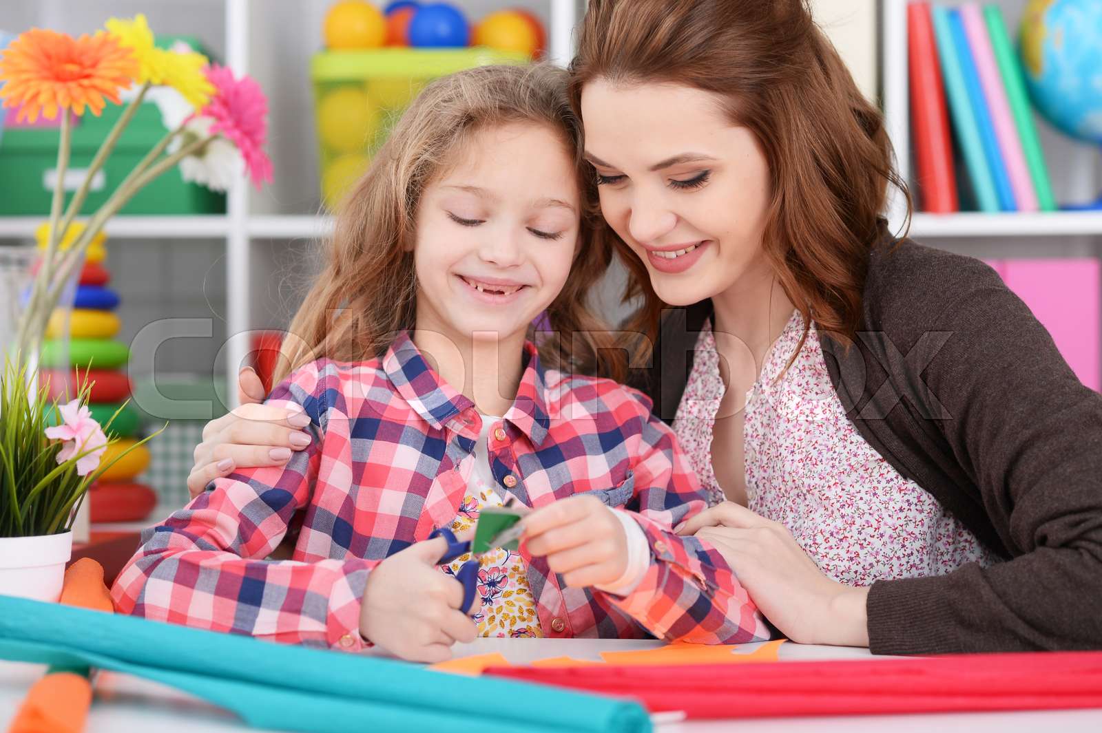 Portrait of cute little girl doing homework | Stock image | Colourbox