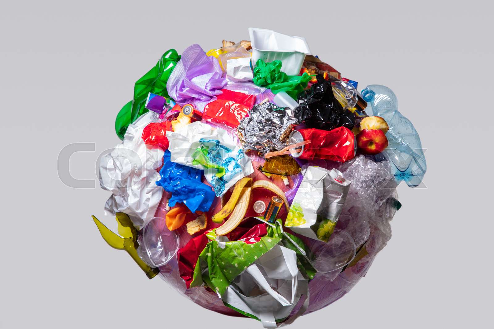 A globe of the earth with trash over white background, the concept of ...