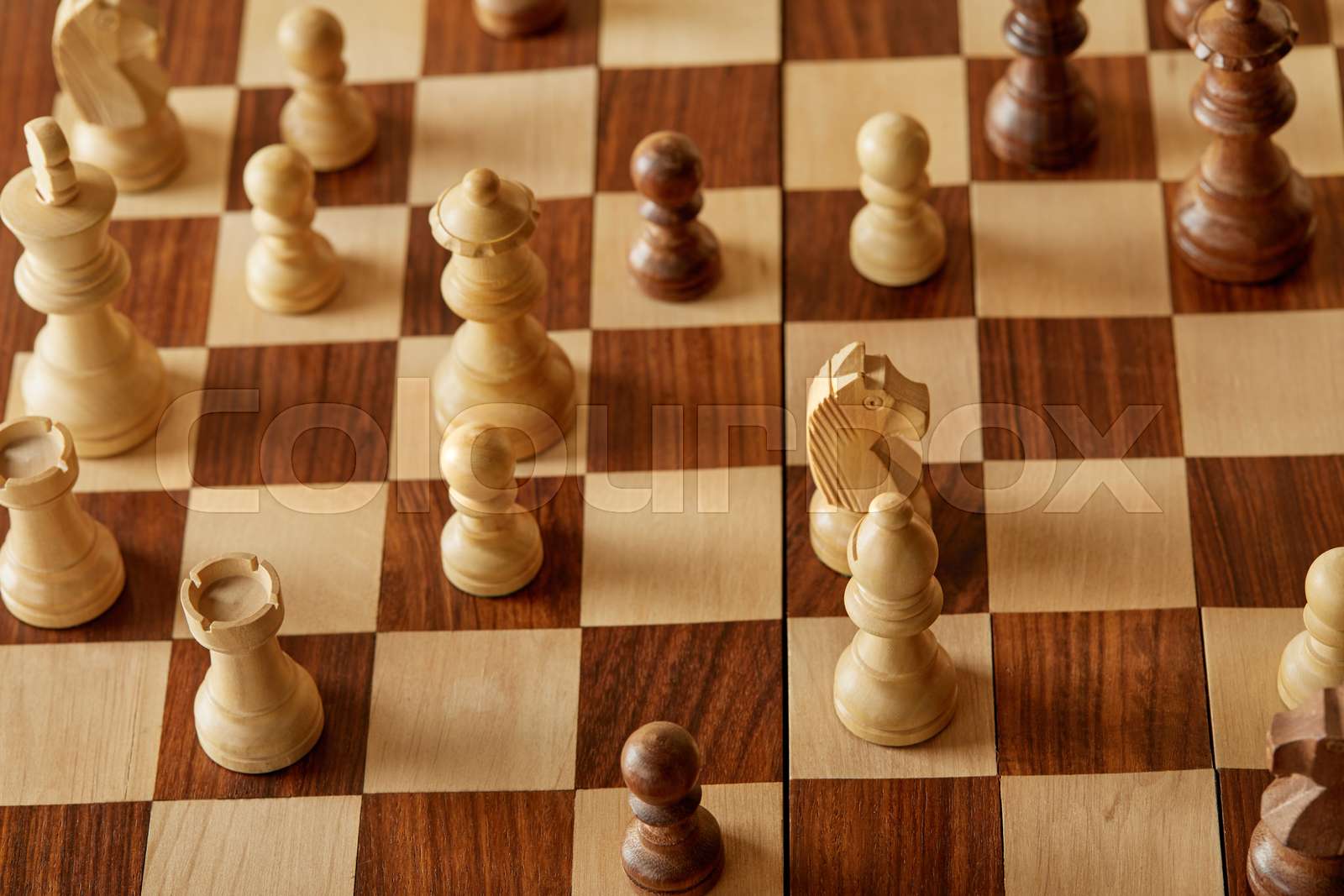 beige and brown chess pieces on wooden chess board | Stock image ...