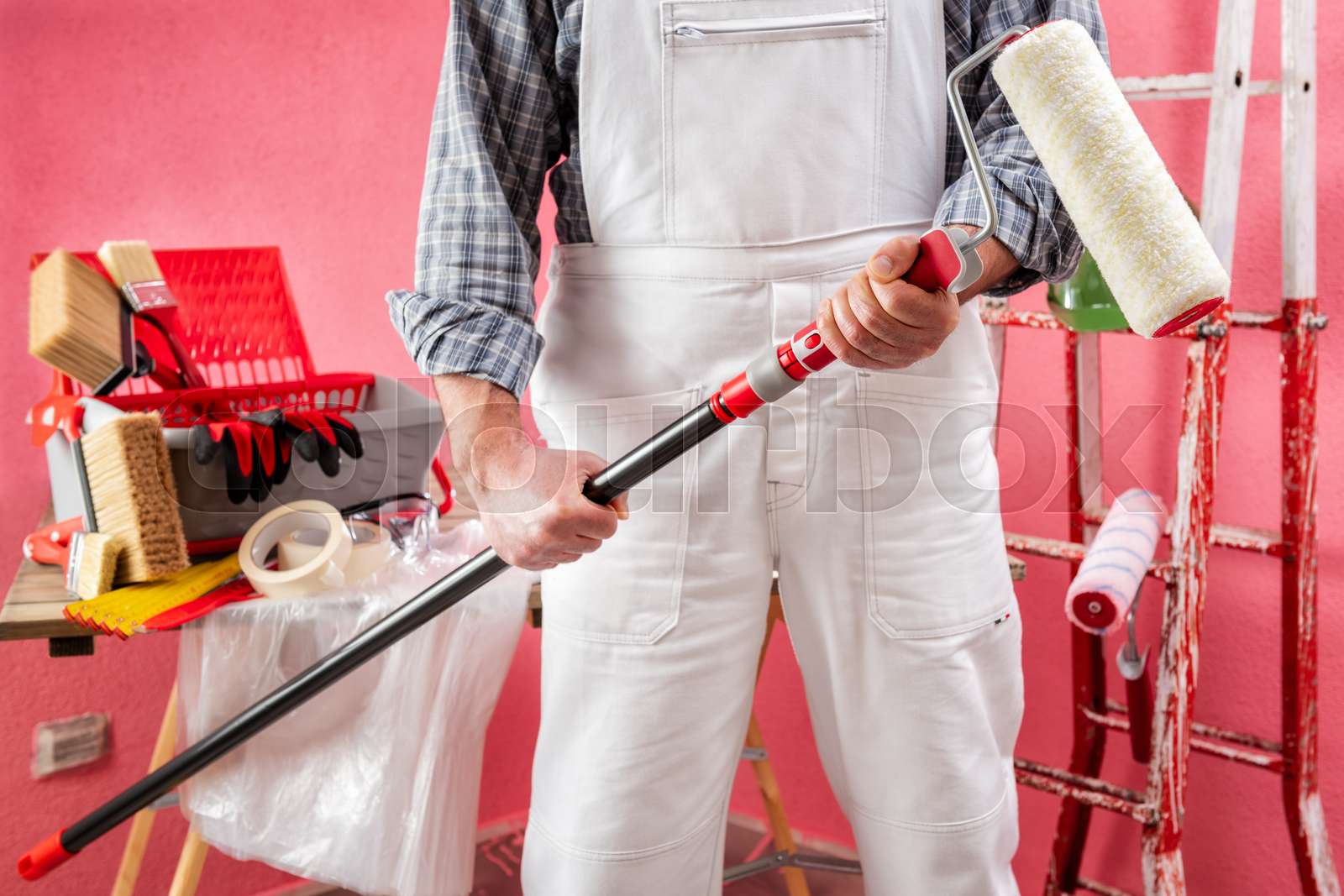Professional house painter at work on the construction site. | Stock ...