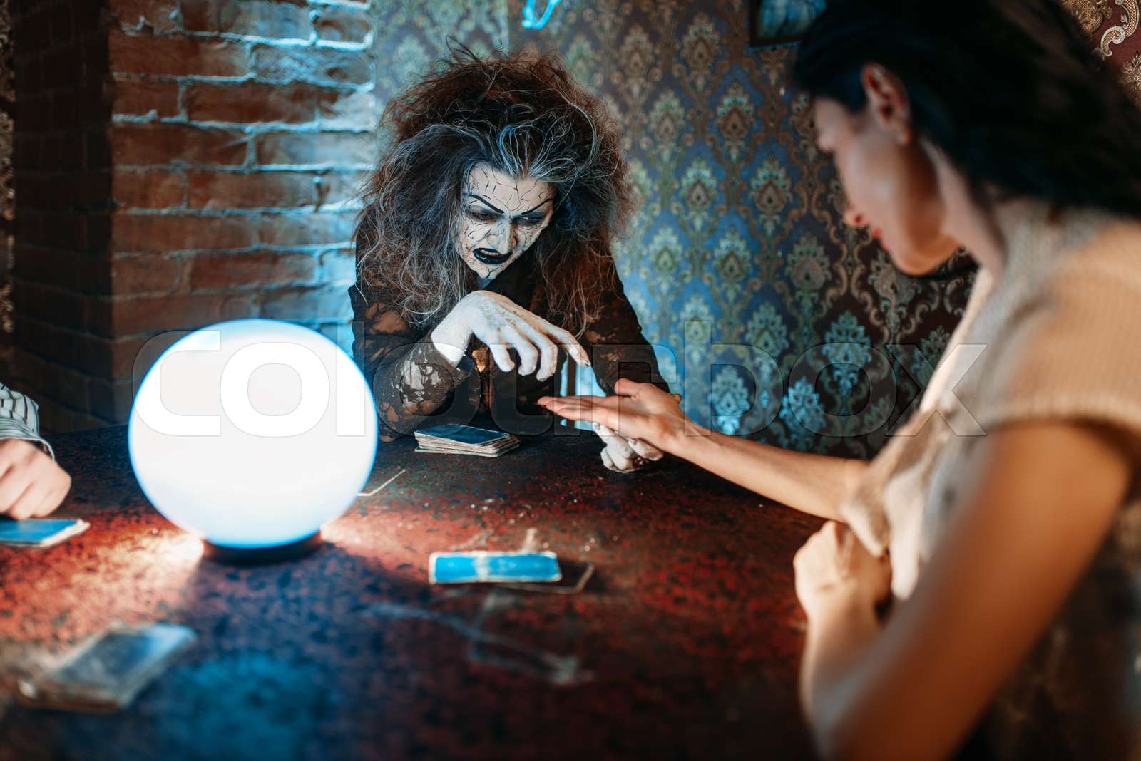 Foreteller guessing by hand over a crystal ball | Stock image | Colourbox