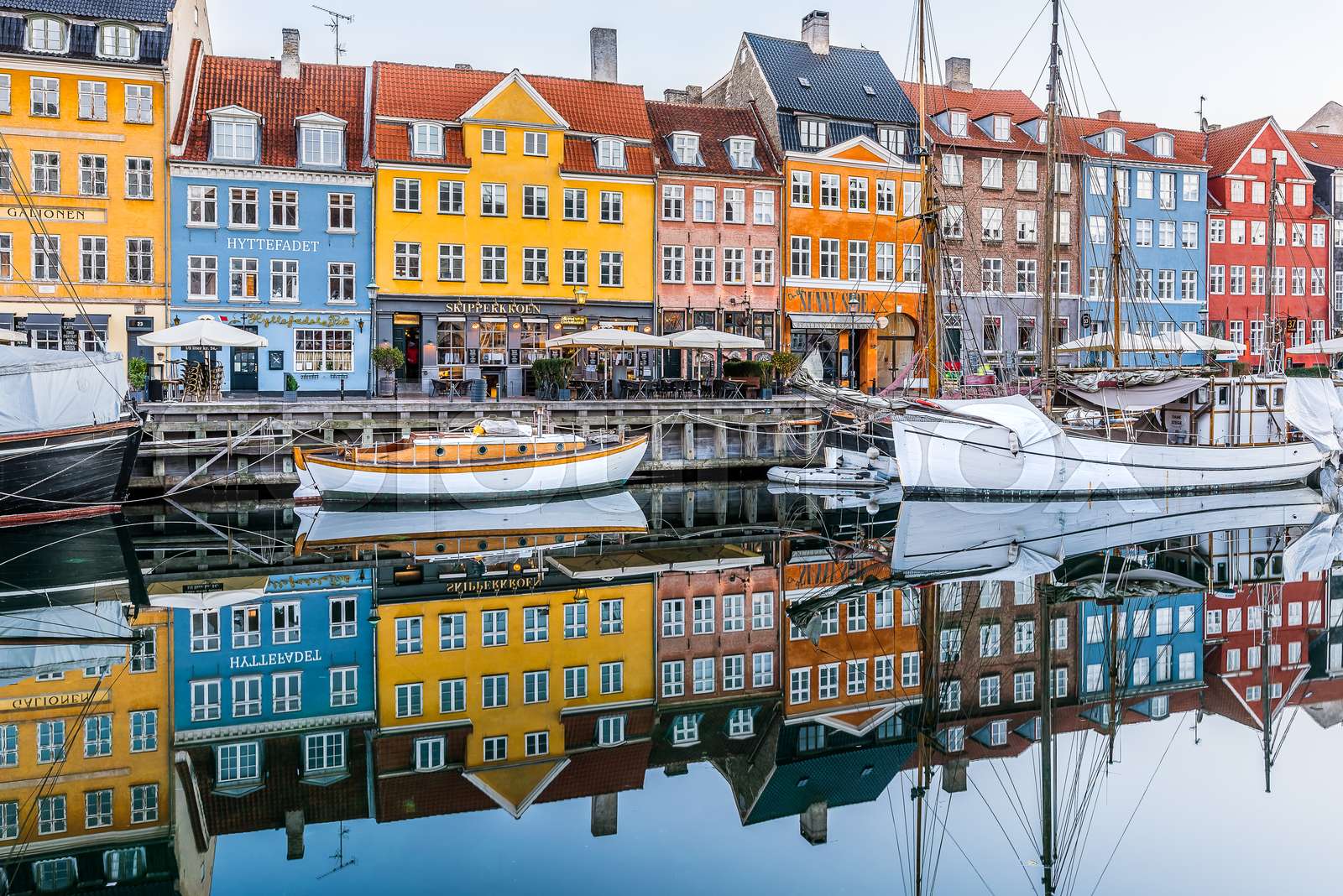 Reflections of colourful houses in the water of Nyhavn canal in ...
