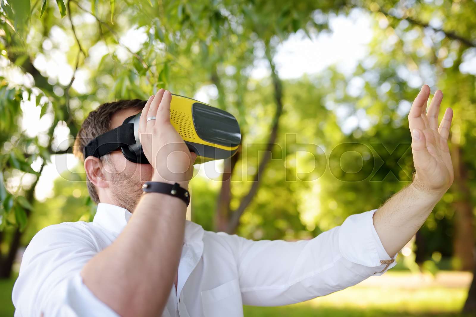 Mature man using virtual reality headset outdoor. VR, VR glasses ...