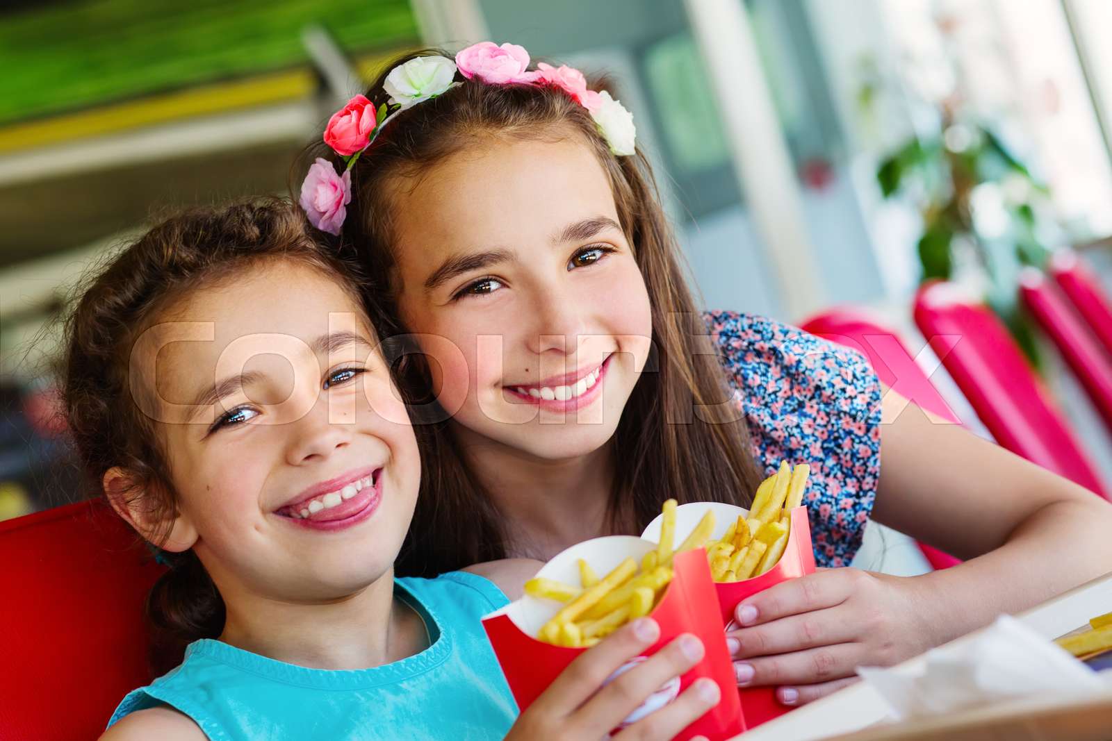 two happy girls in fast food restaurant | Stock image | Colourbox