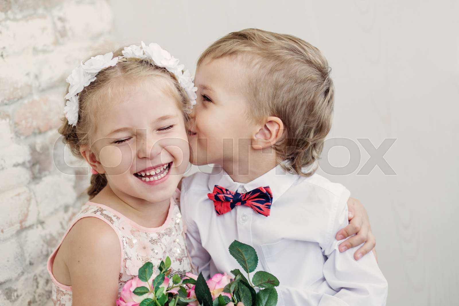 Happy little children embrace and kiss | Stock image | Colourbox