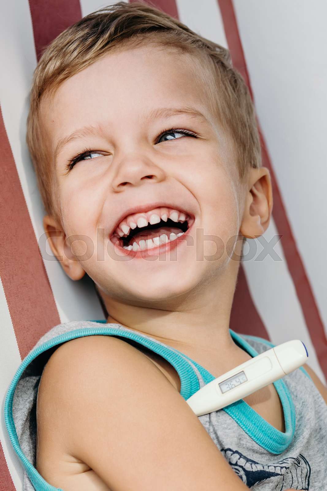 happy laughing little boy measuring temperature | Stock image | Colourbox