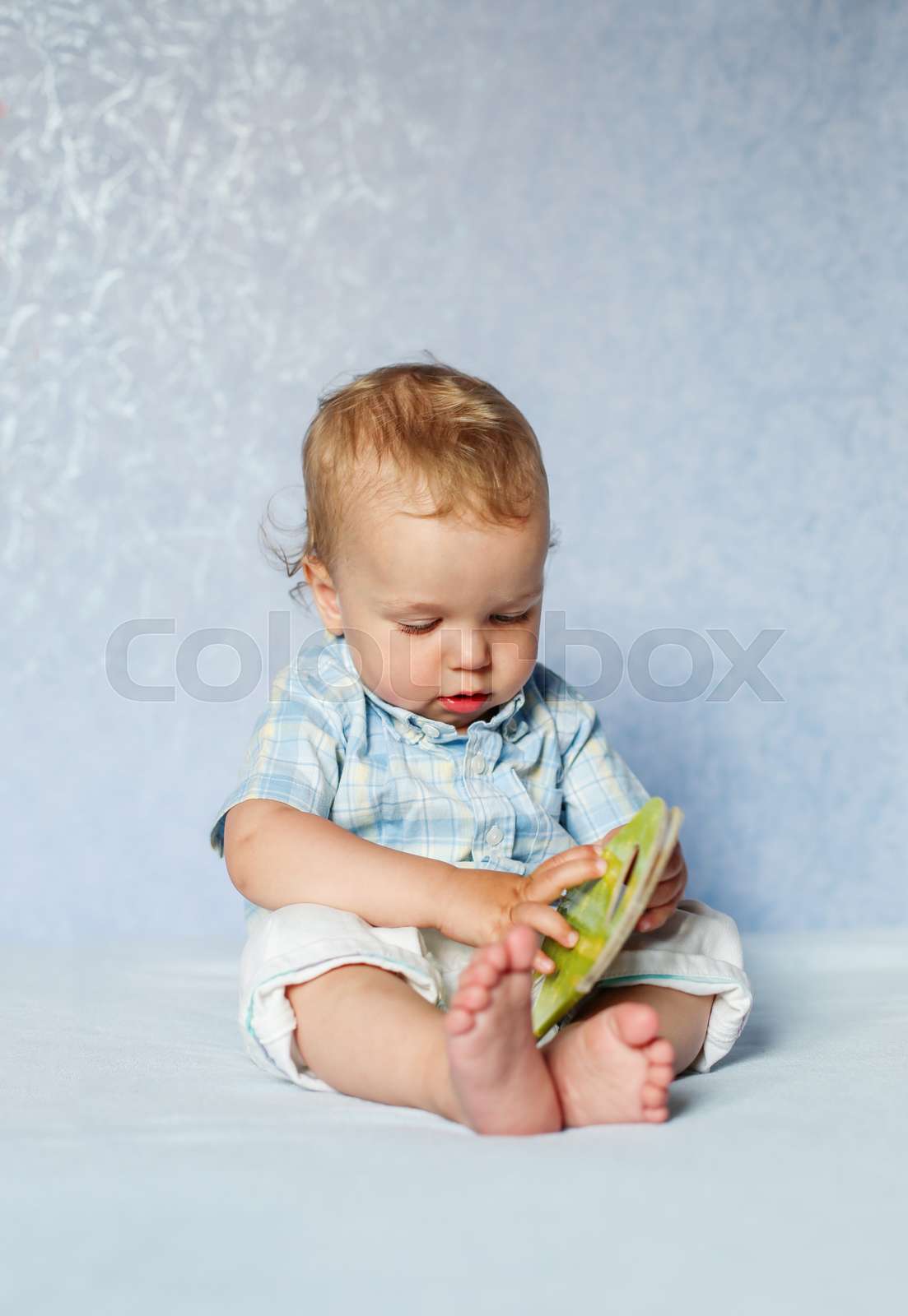 cute baby studying the book sitting | Stock image | Colourbox