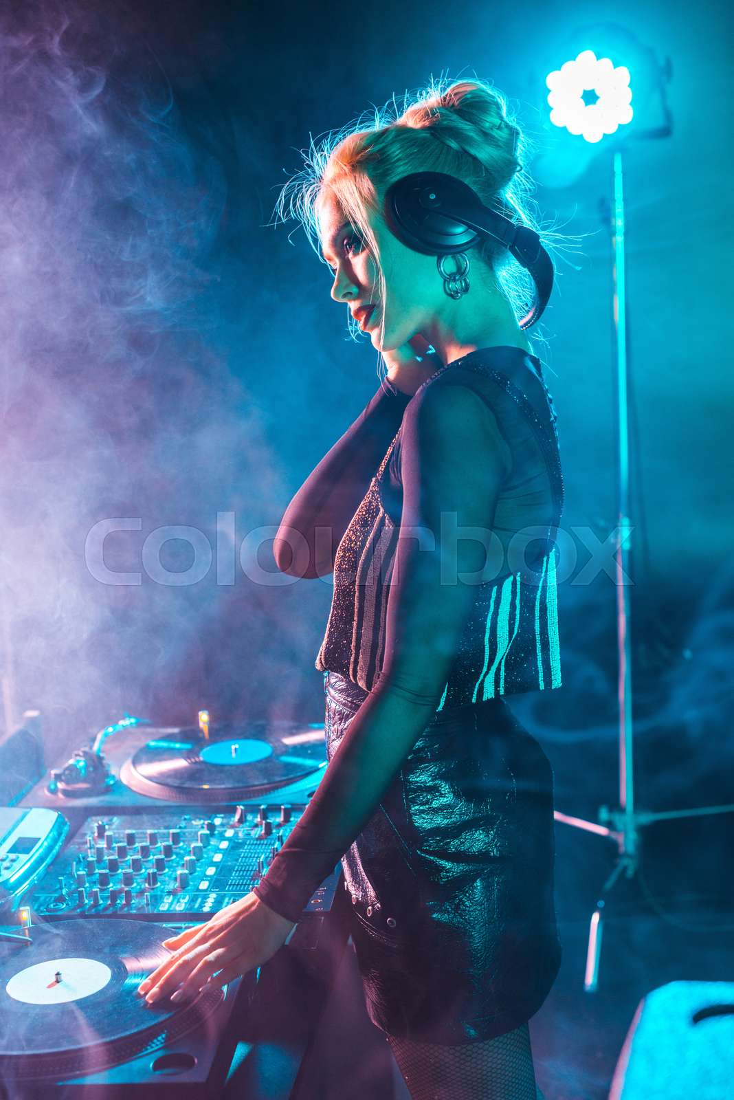 beautiful dj woman with blonde hair listening music and holding ...