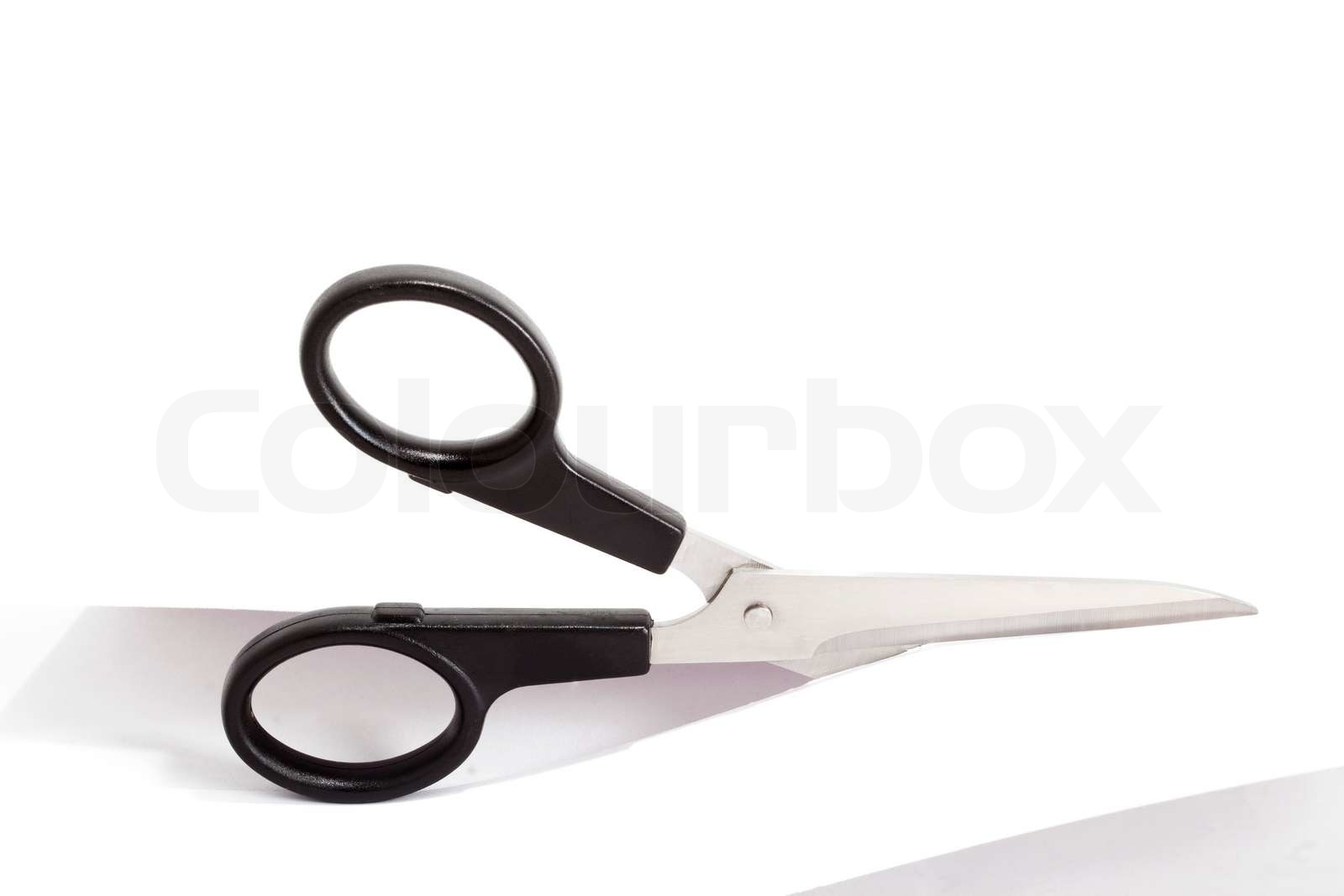 Scissors cutting a paper | Stock image | Colourbox