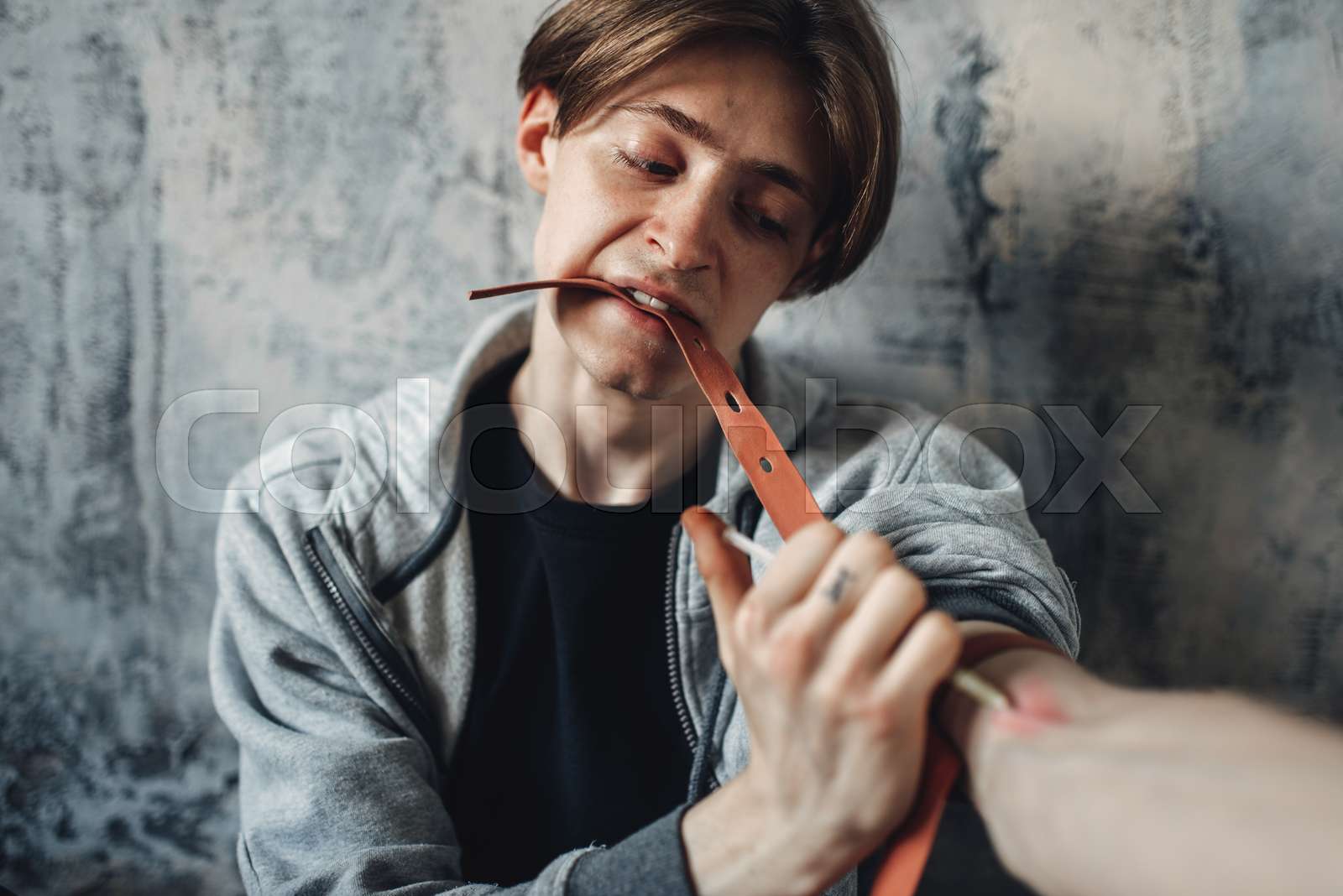 Male junkie with syringe doing an injection dose | Stock image | Colourbox