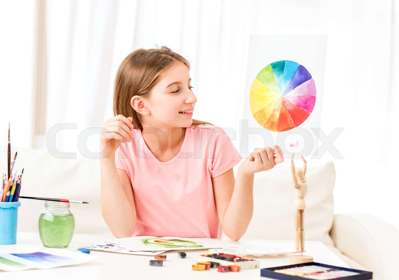 Girl showing her drawing | Stock image | Colourbox