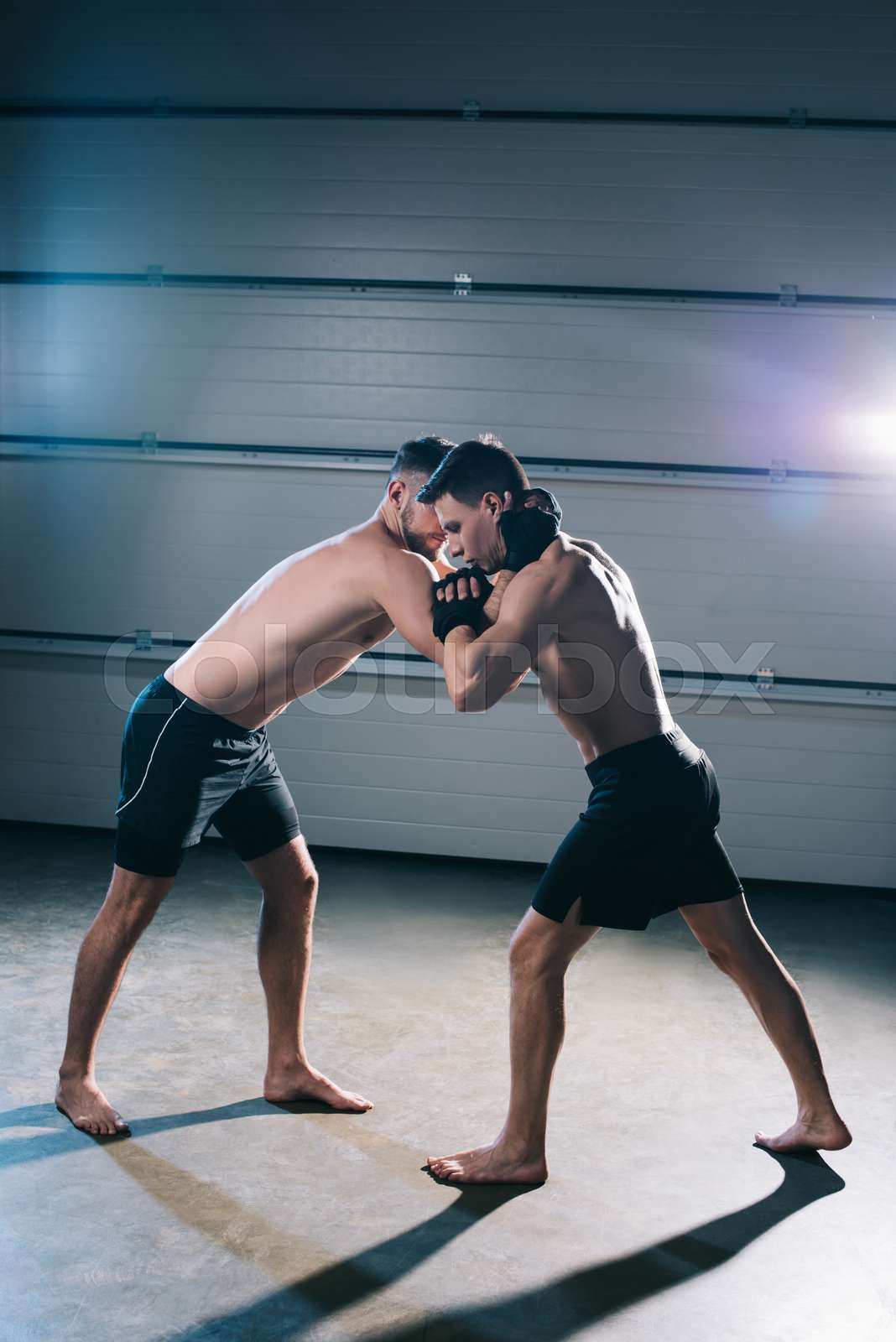 muscular barefoot mma fighter clinching sportive opponent | Stock image ...