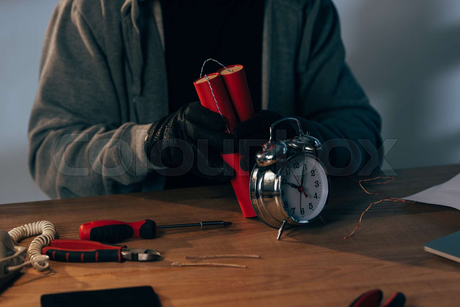 Cropped view of criminal in leather gloves making bomb | Stock image ...