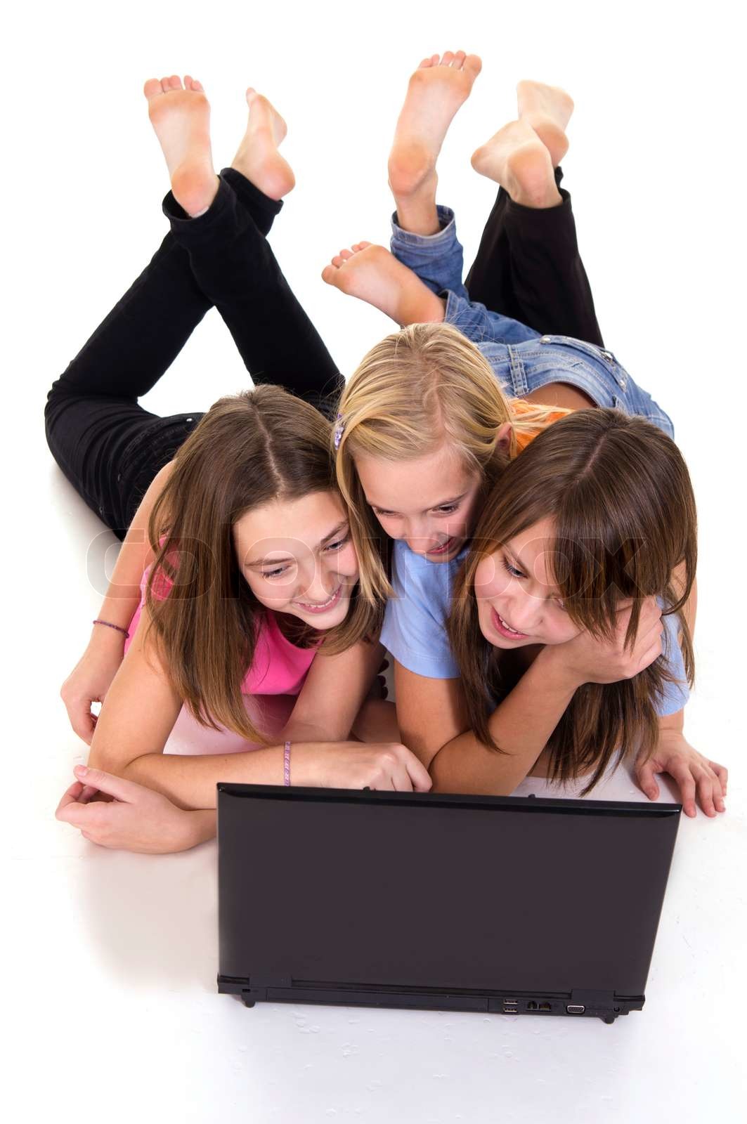 cute young girls with computer on white | Stock image | Colourbox