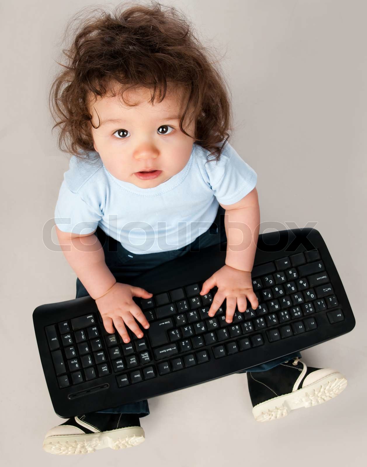 little kid with a computer keyboard | Stock image | Colourbox