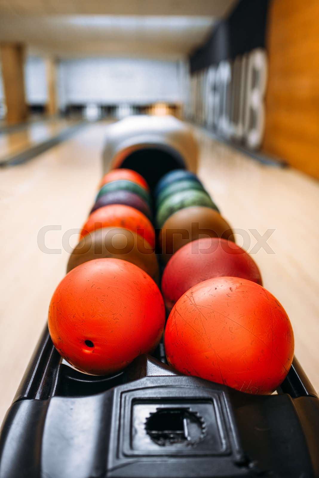 Color bowling balls in feeder, bowl game concept | Stock image | Colourbox
