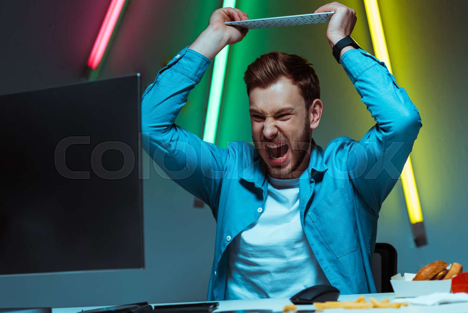 handsome and angry man holding computer keyboard and screaming | Stock ...