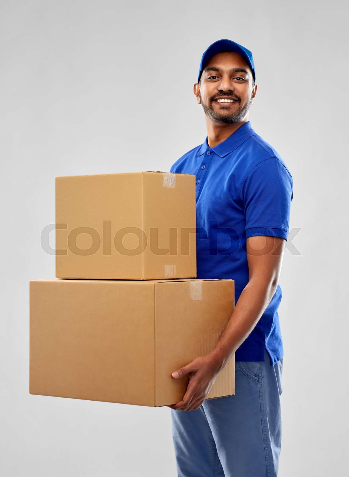 happy indian delivery man with parcel boxes | Stock image | Colourbox