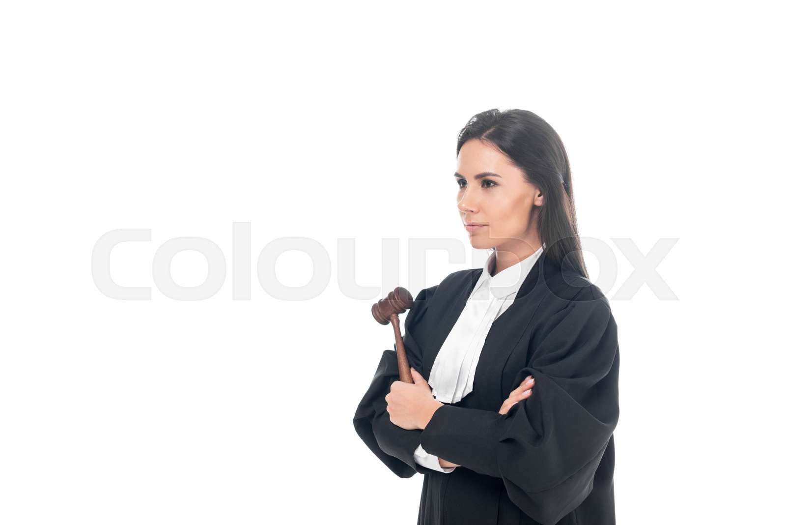 Judge in judicial robe holding gavel and standing with folded arms ...
