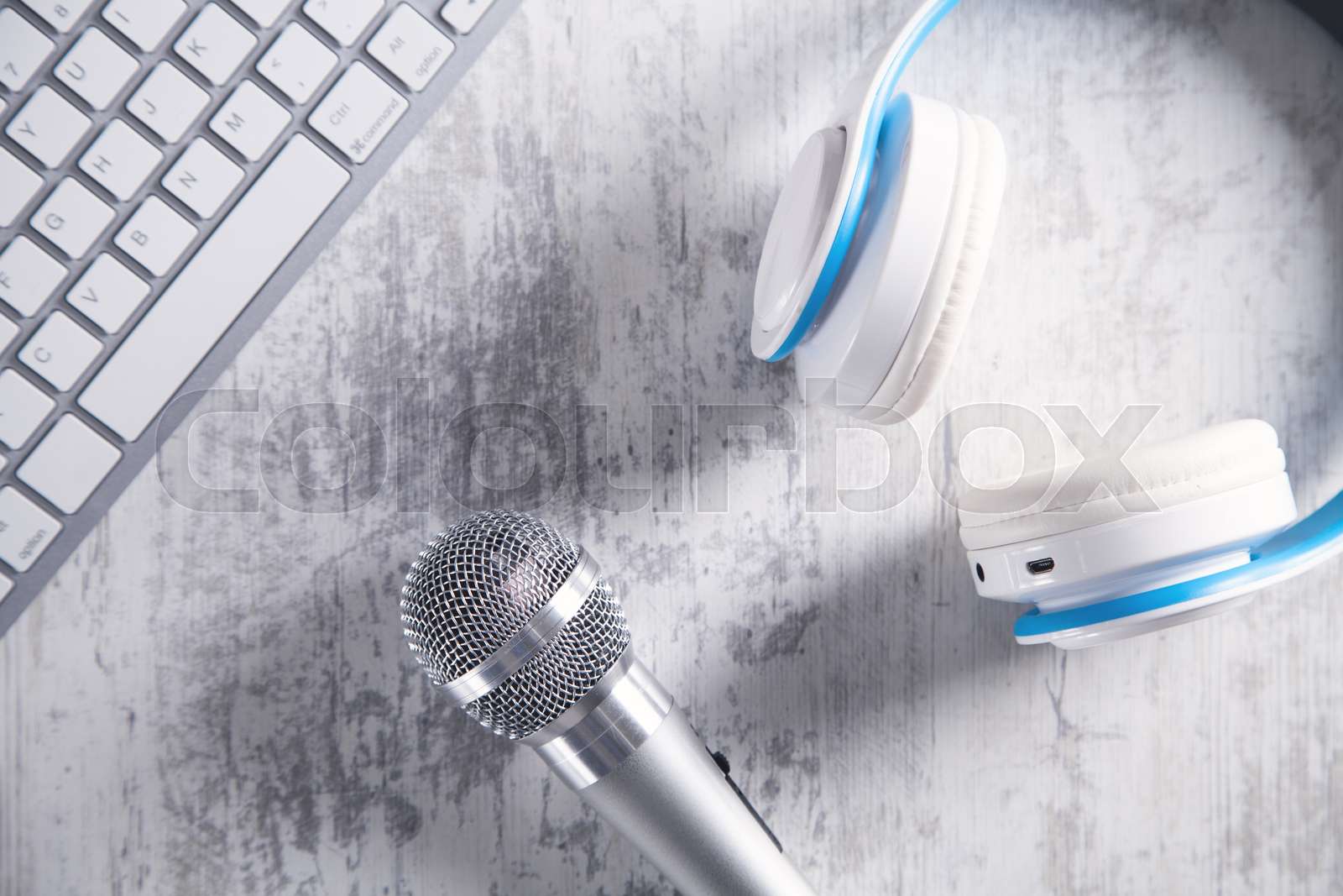 Microphone, keyboard and headphones on a white desk. Top View | Stock ...