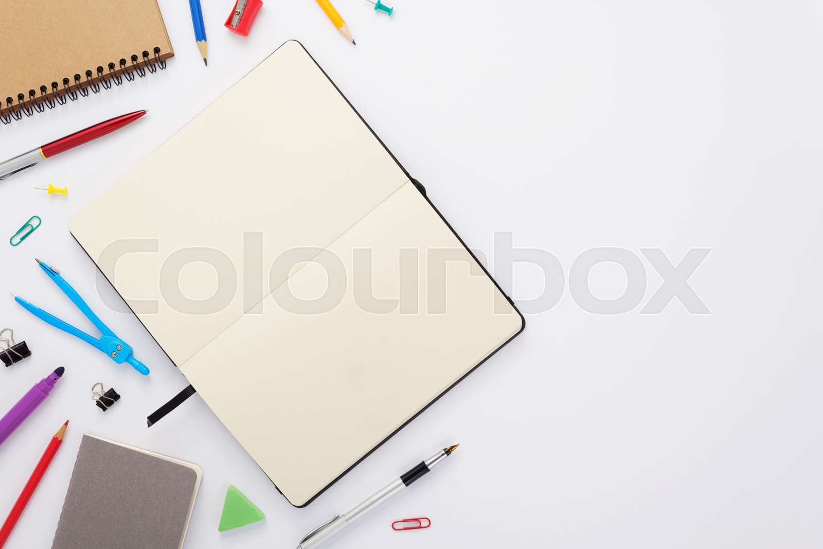 paper notebook and school supplies at white | Stock image | Colourbox