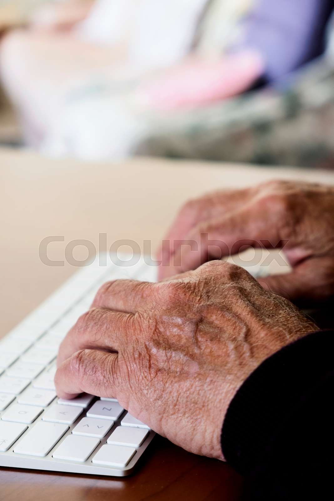 old caucasian man typing in a keyboard | Stock image | Colourbox