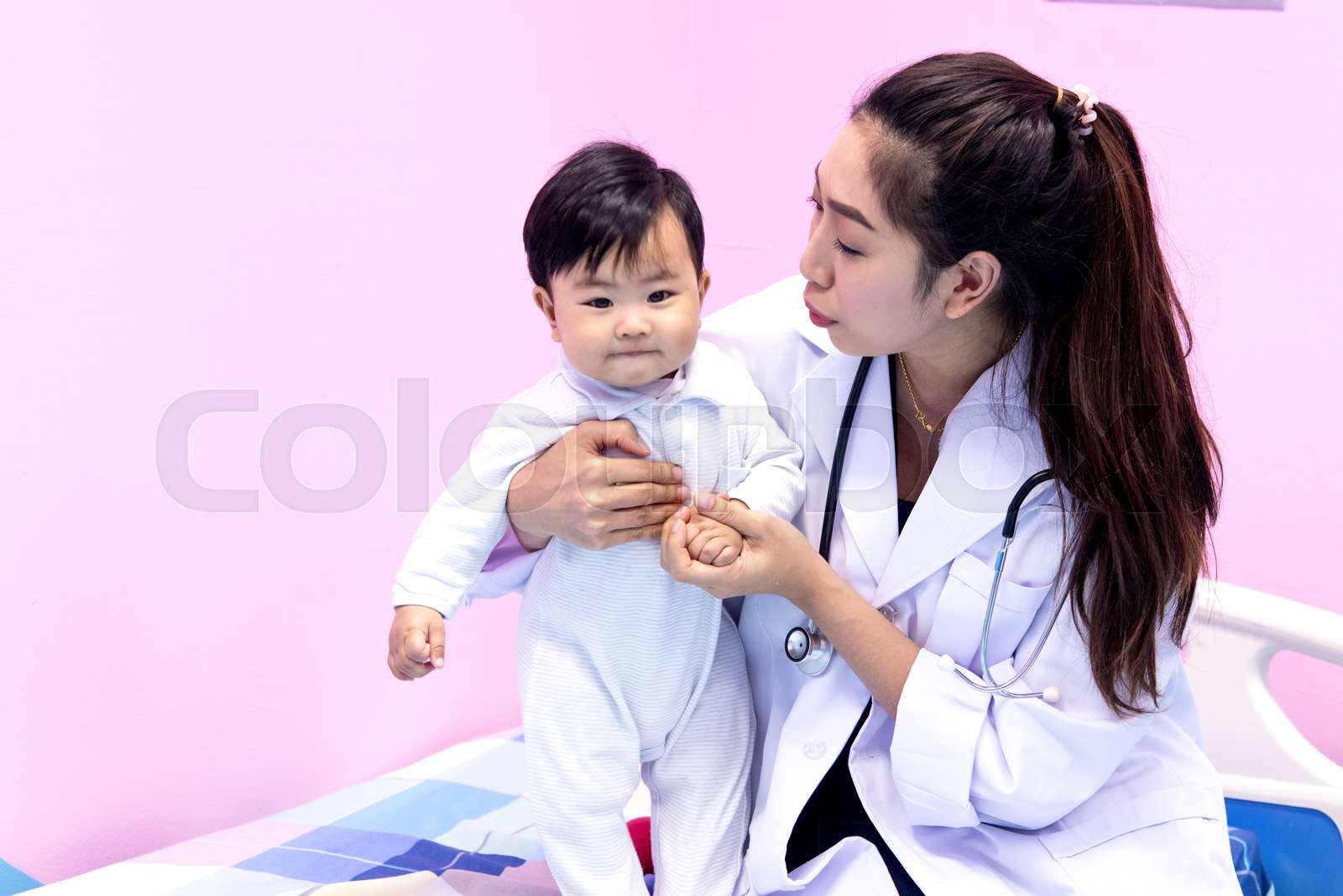 Doctor holding baby in hands. | Stock image | Colourbox