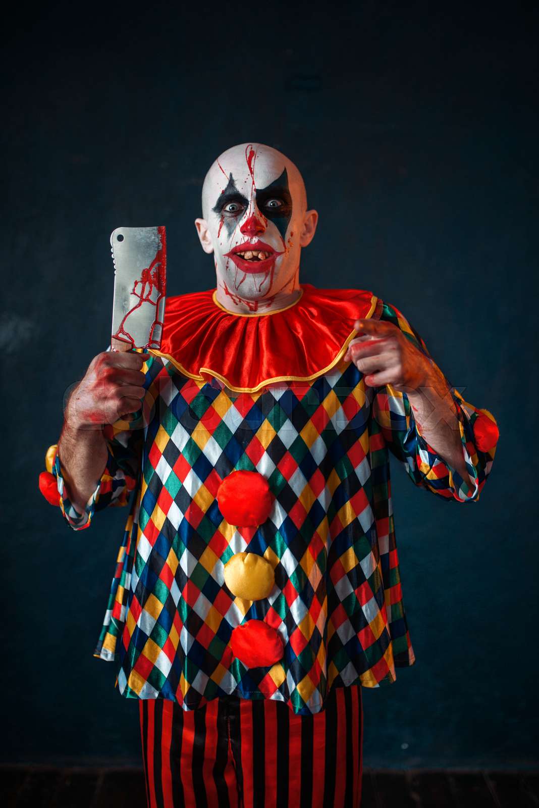 Bloody clown with meat cleaver and baseball bat | Stock image | Colourbox