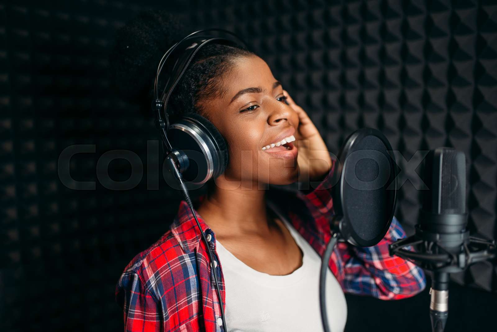 Female singer songs in audio recording studio | Stock image | Colourbox