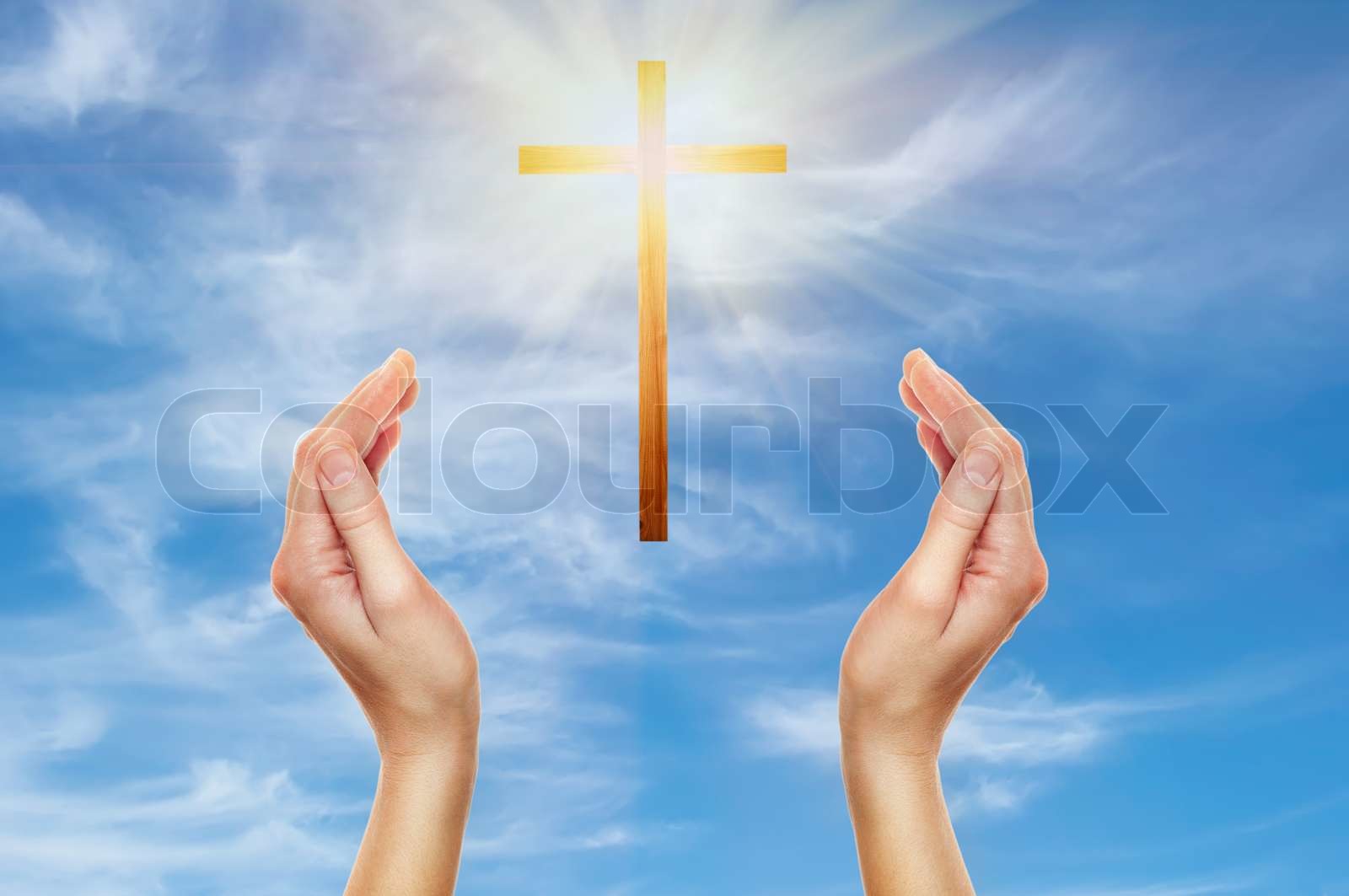hands praying with a wooden cross | Stock image | Colourbox
