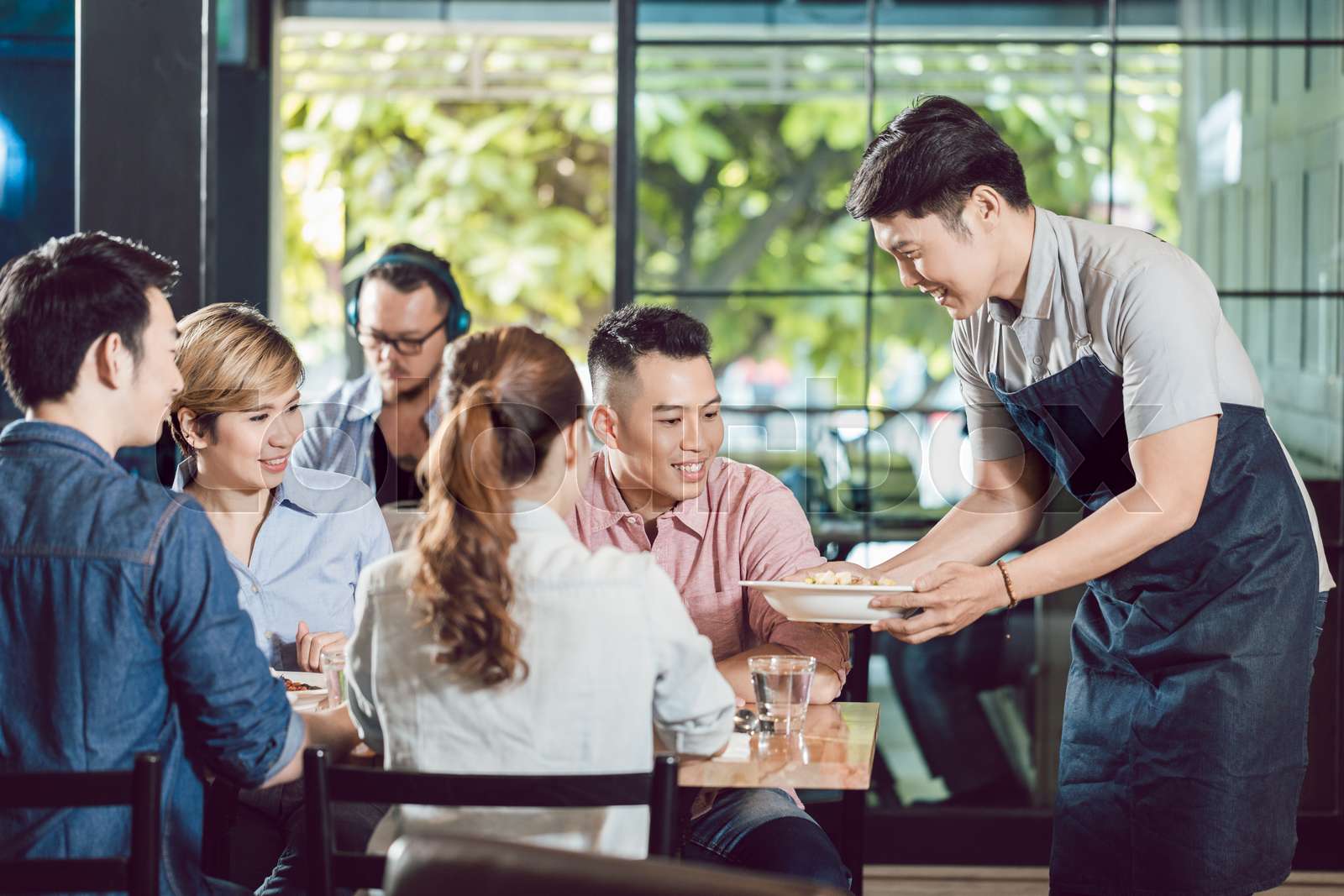 Waiter serving food in the restaurant | Stock image | Colourbox