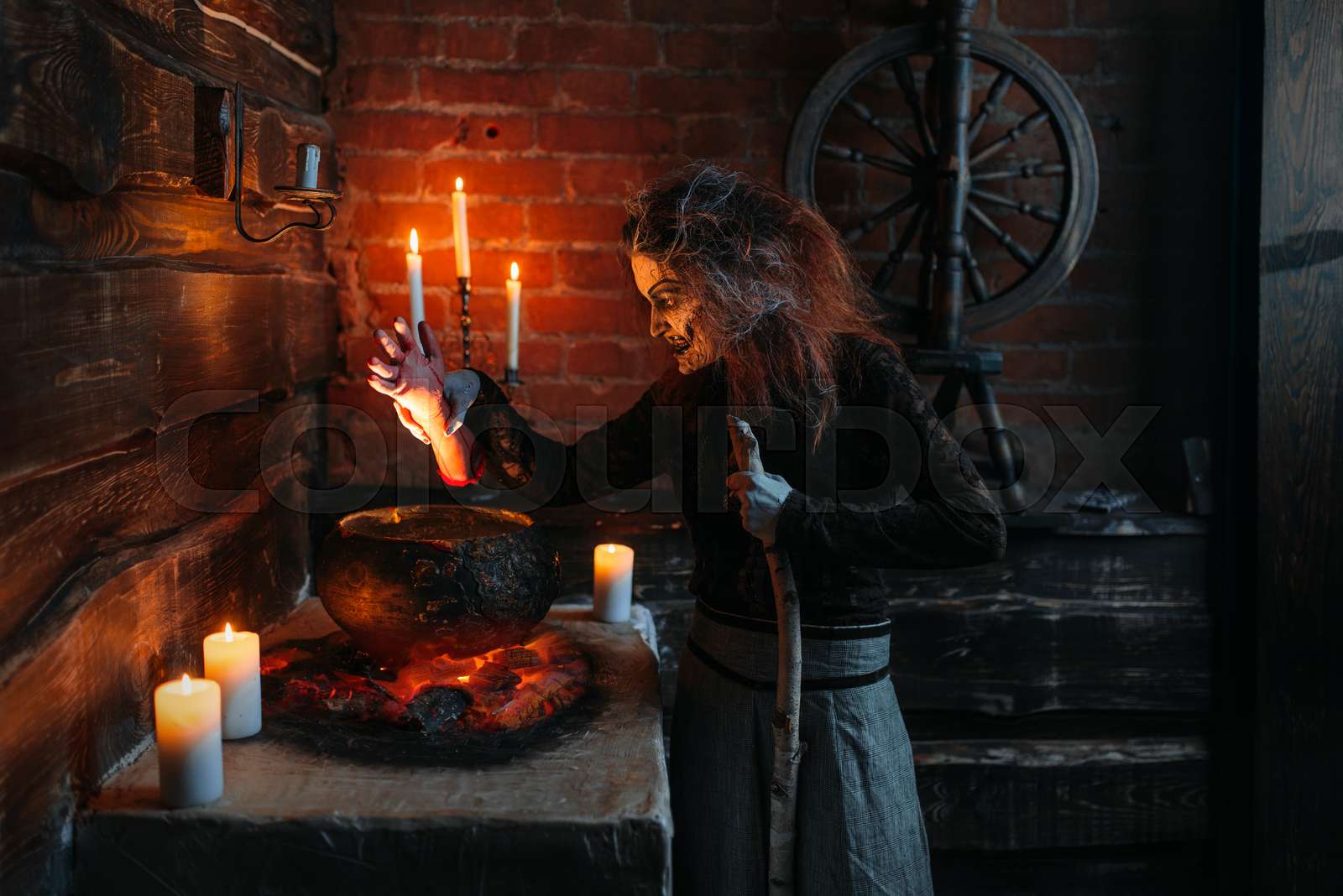 Scary witch reads spell over the pot, seance | Stock image | Colourbox