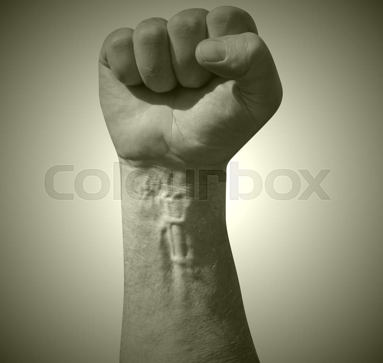 Raised clenched fist of adult male in the air as a threat of fighting ...