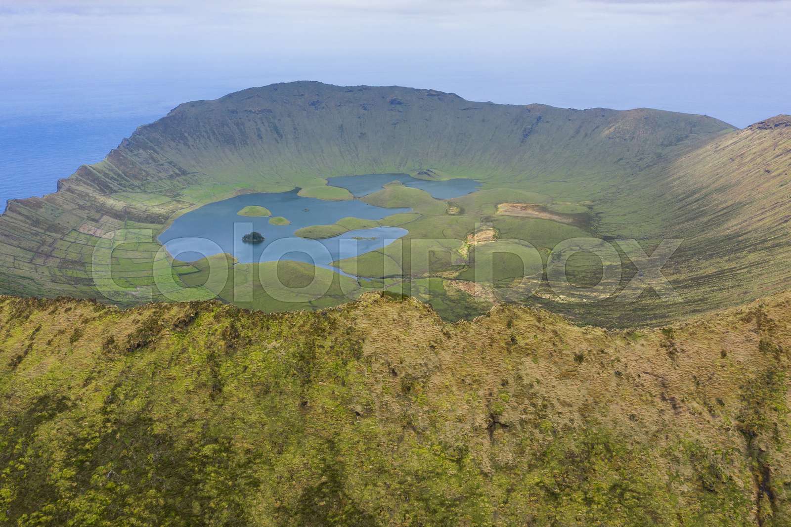 Aerial view of volcanic crater (Caldeirao) with a beautiful lake on the ...